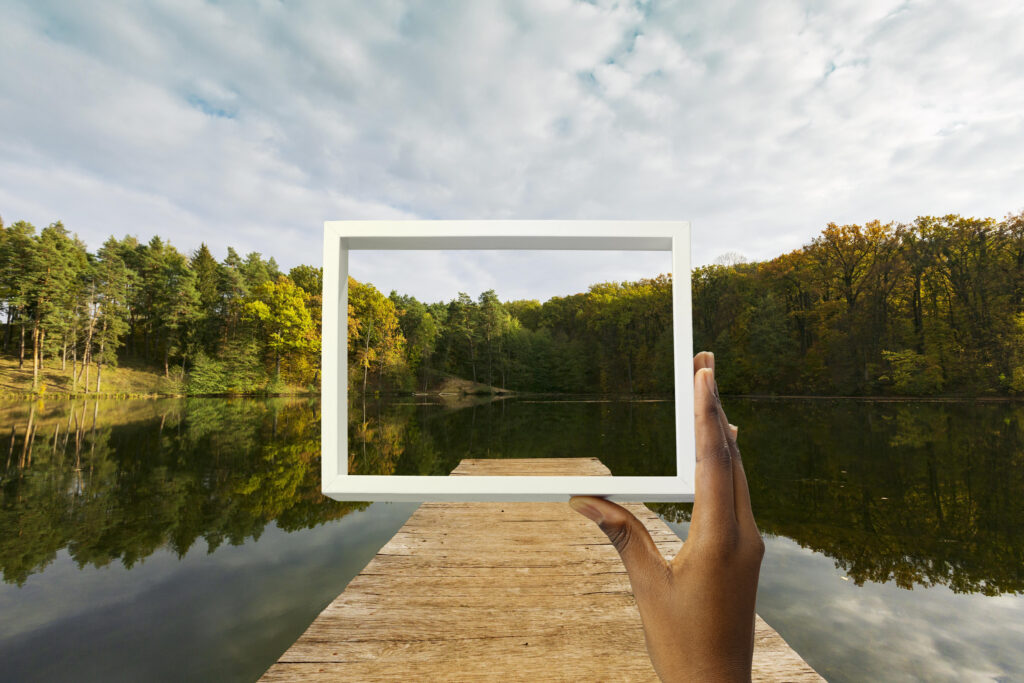 nature-landscape-with-hand-holding-frame - Qantara